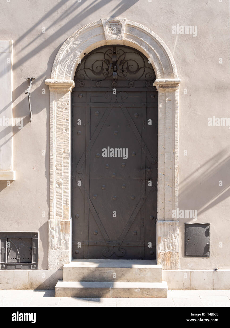 A metal door of a Renaissance tenement house. Facade of a Renaissance ...
