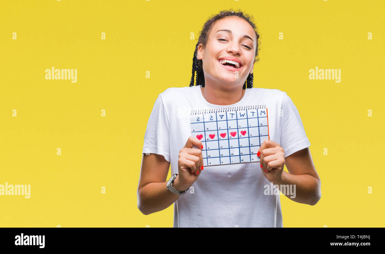 Young braided hair african american girl holding menstruation calendar ...