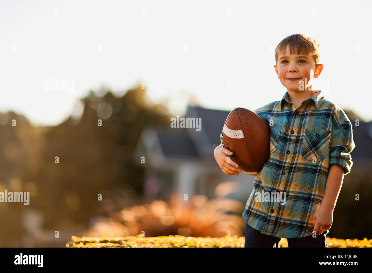 Portrait of boy holding his rugby ball in the backyard Stock Photo - Alamy