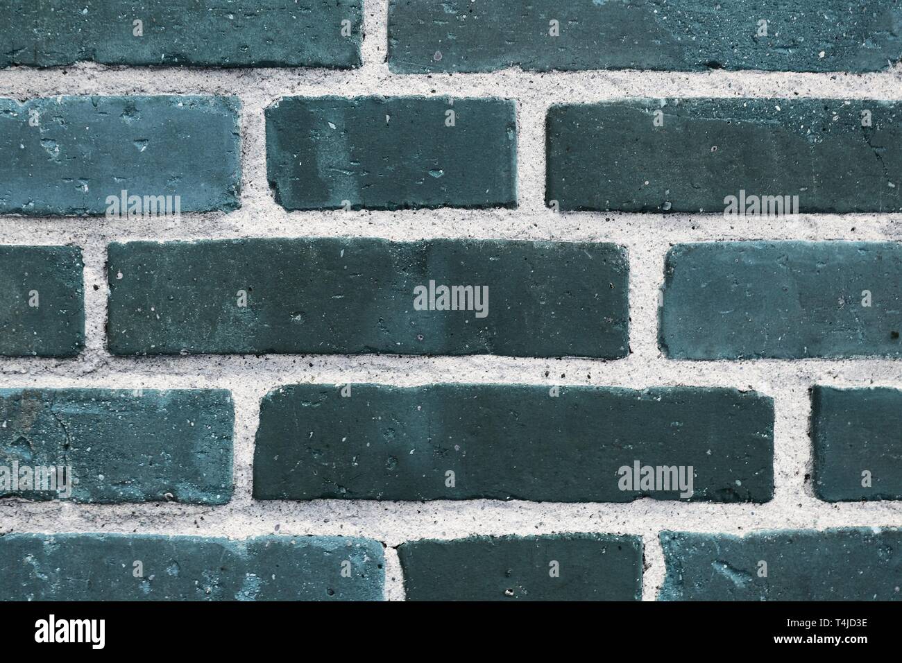 Beautiful aged and weathered blue brick wall surfaces in a close up ...
