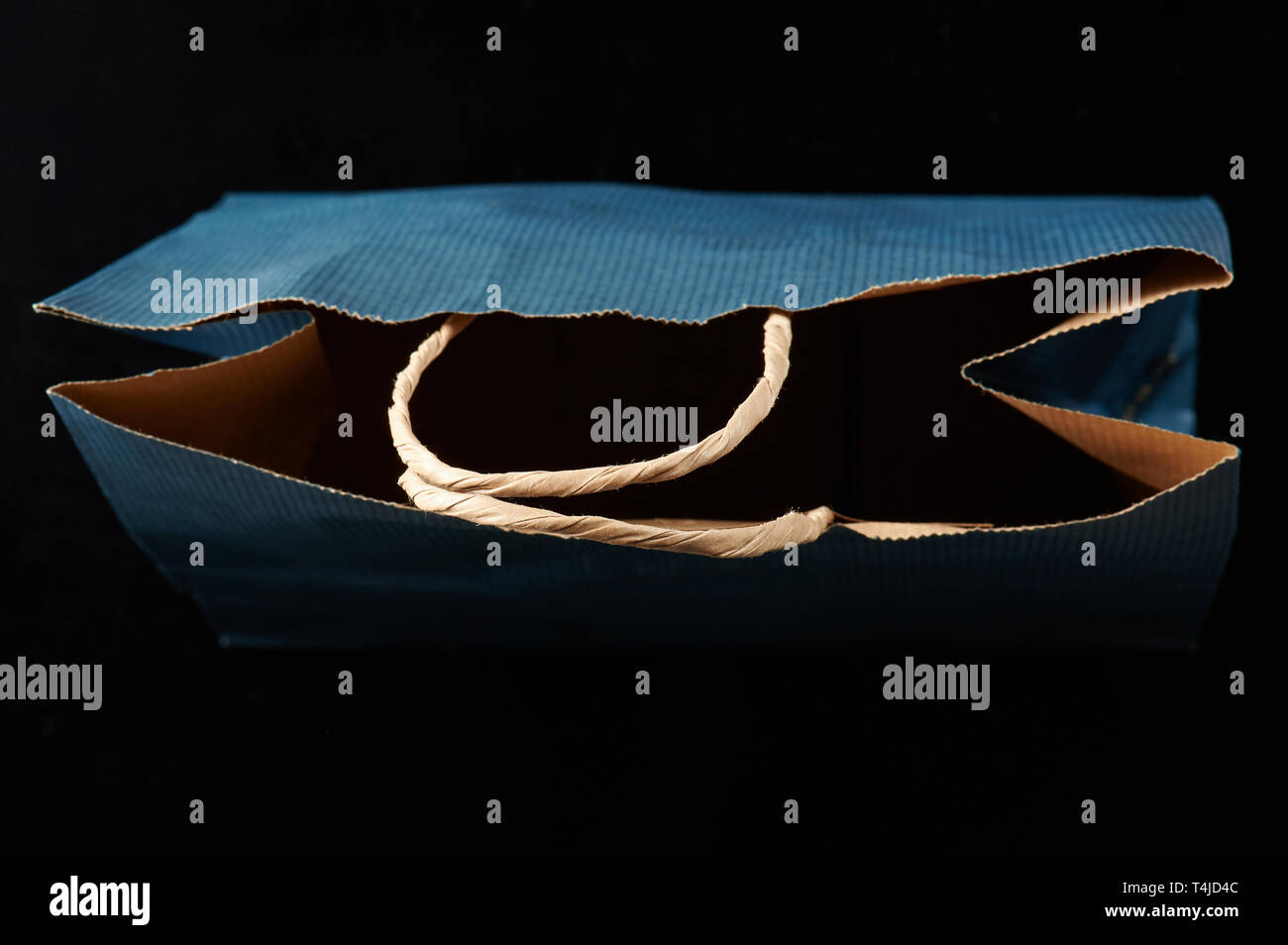 Open blue paper shopping bag top view isolated on black background ...