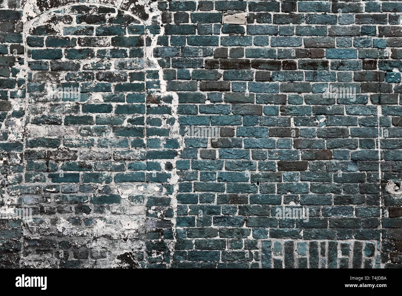 Beautiful aged and weathered blue brick wall surfaces in a close up ...