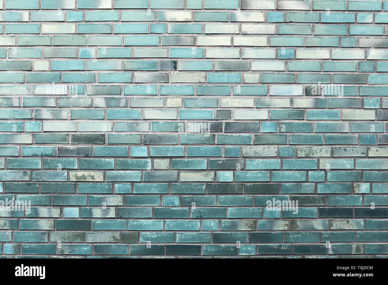 Beautiful aged and weathered blue brick wall surfaces in a close up ...