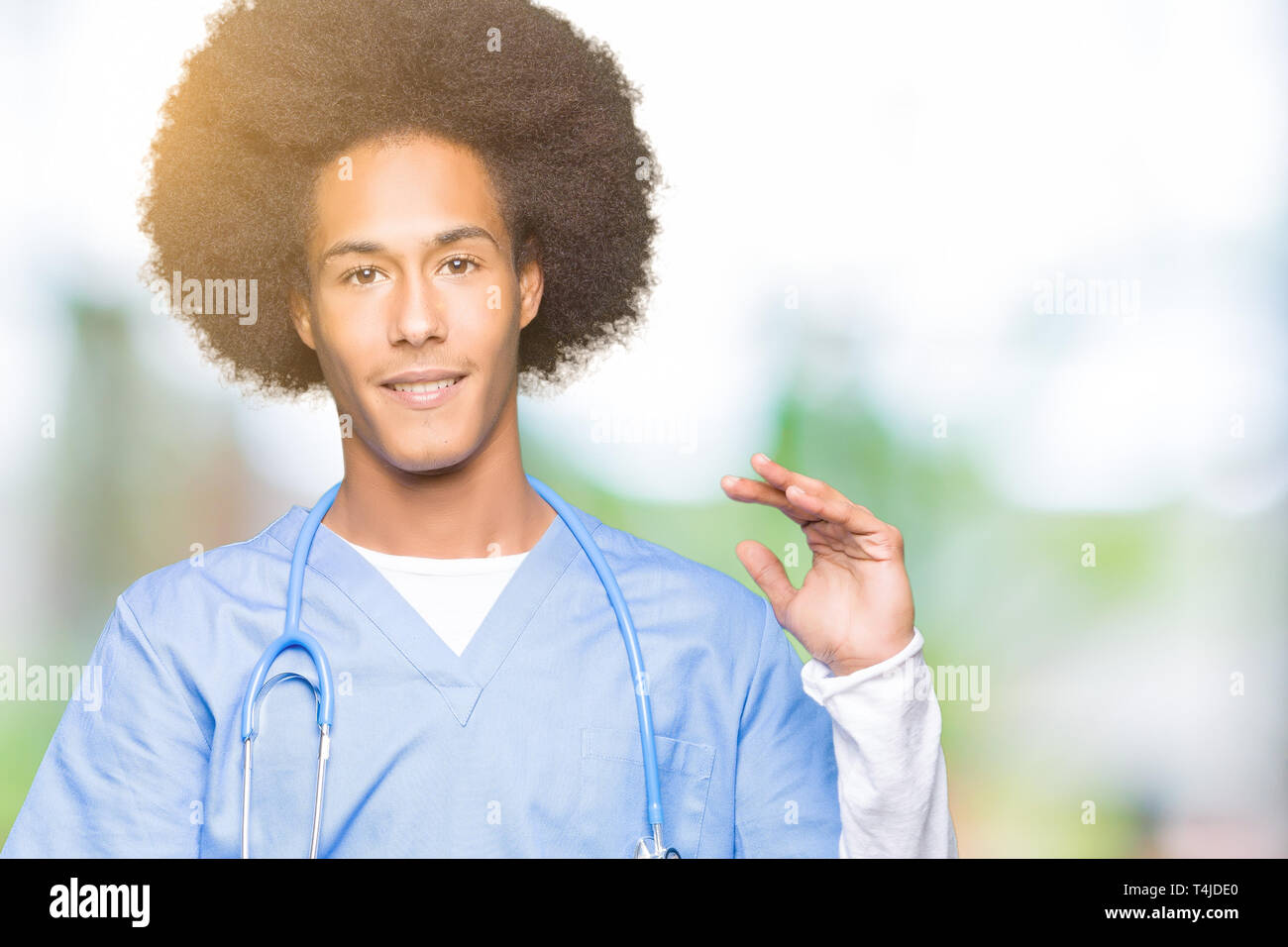 Young african american doctor man with afro hair gesturing with hands ...