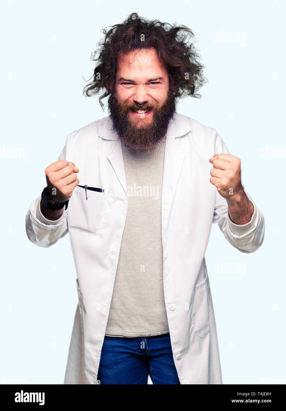 Crazy scientist with funny long hair celebrating surprised and amazed ...