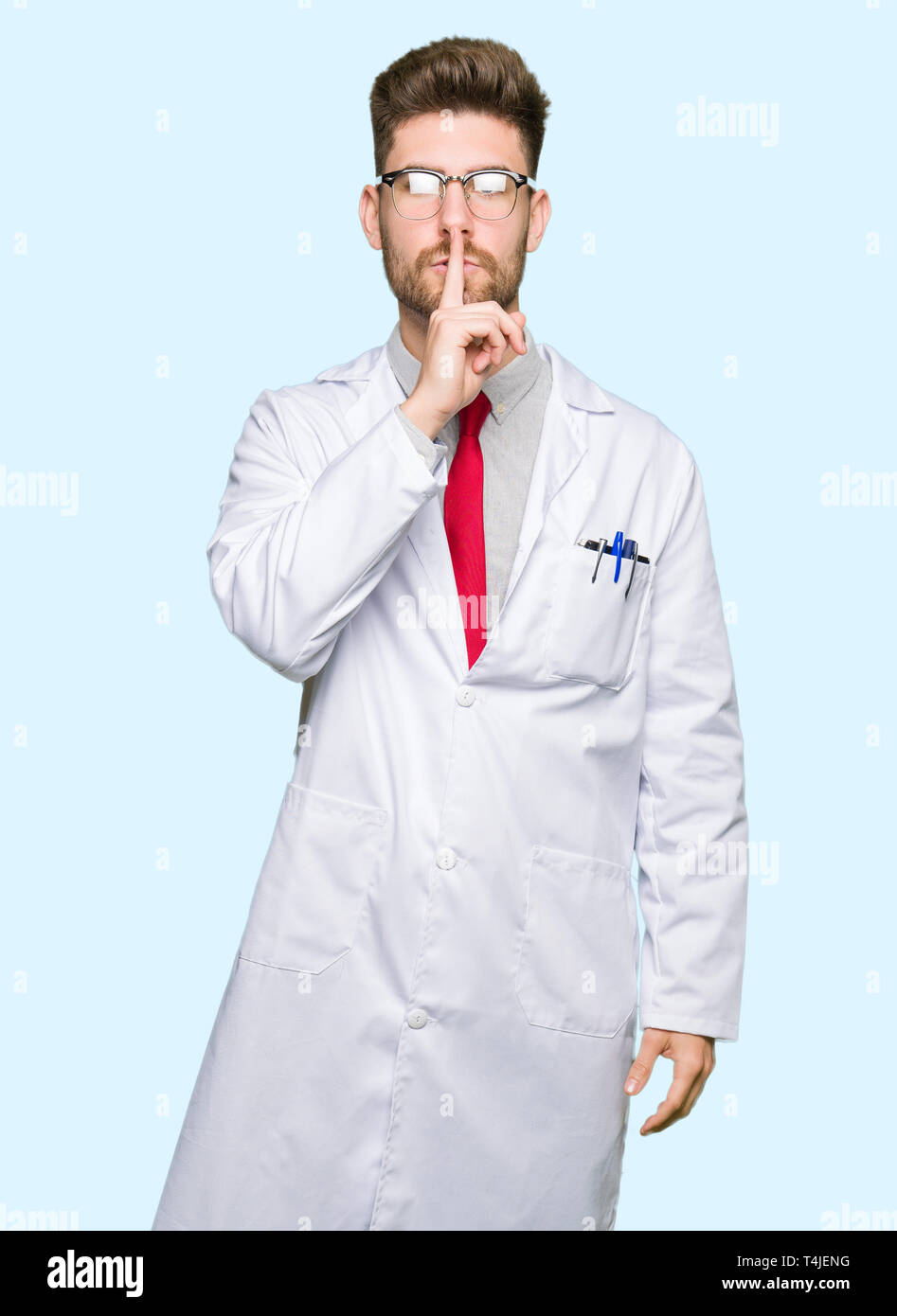 Young handsome scientist man wearing glasses asking to be quiet with ...