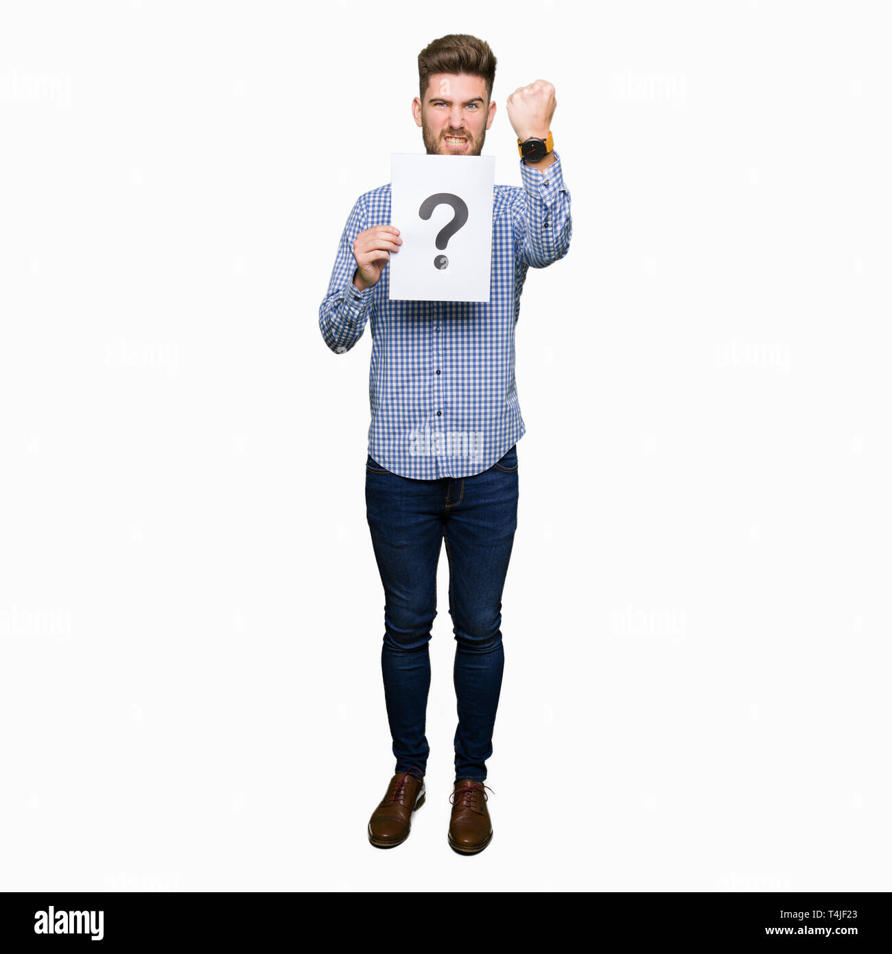 Young handsome man holding paper with question mark annoyed and ...