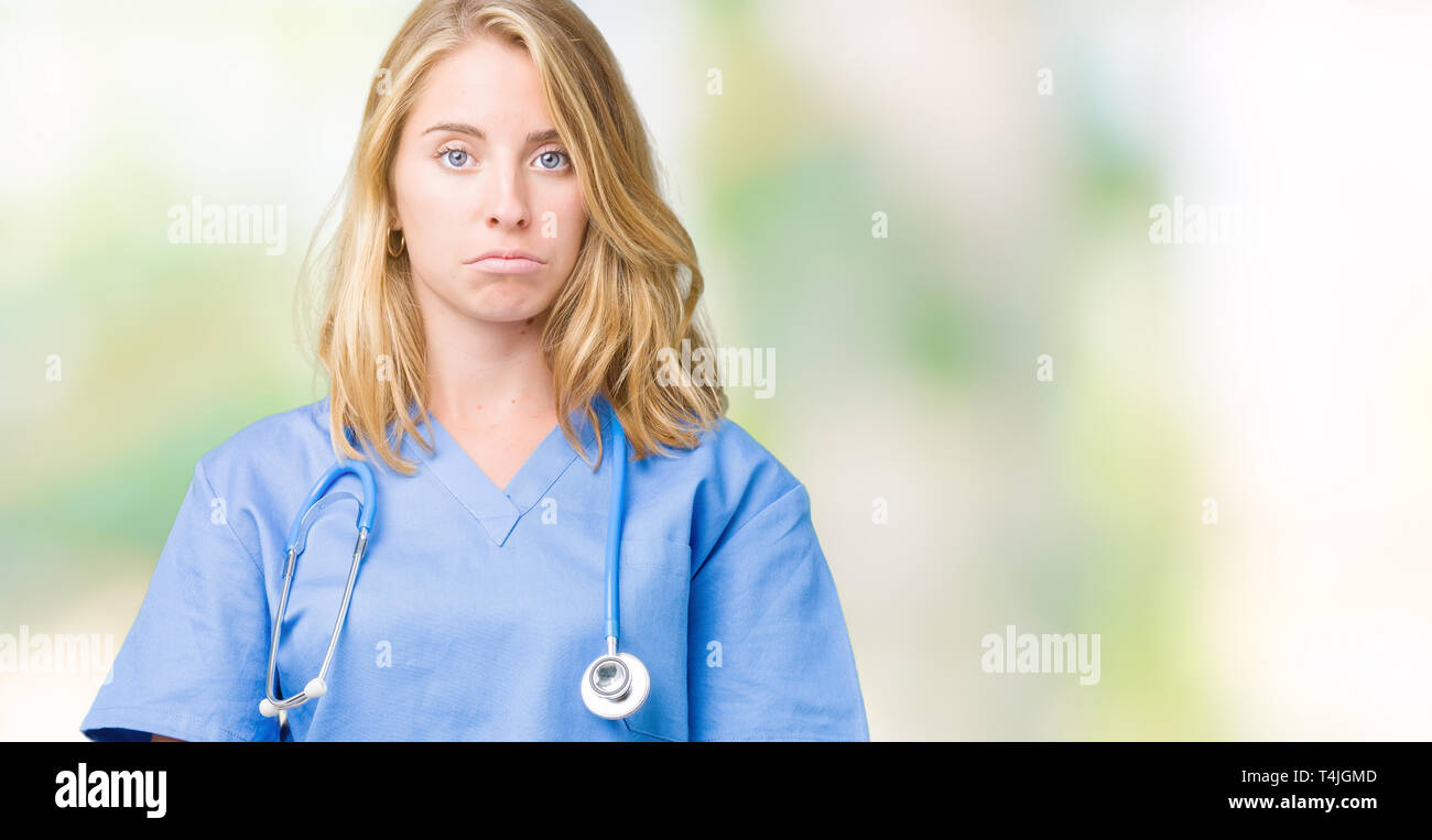 Beautiful young doctor woman wearing medical uniform over isolated ...