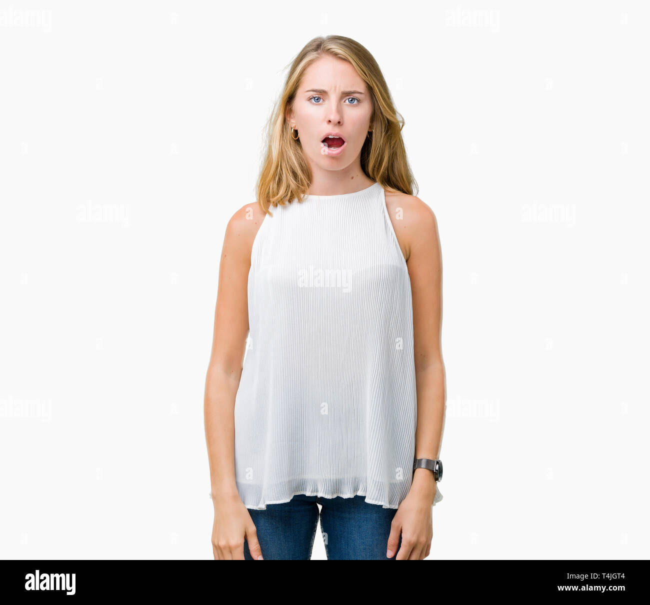 Beautiful young elegant woman over isolated background In shock face ...