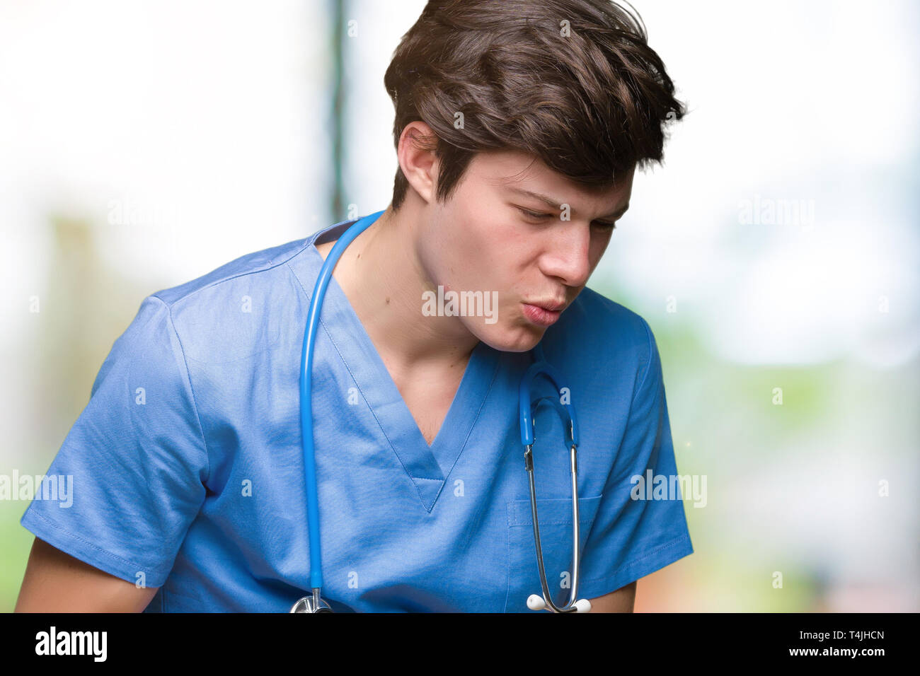 Young doctor wearing medical uniform over isolated background with hand ...