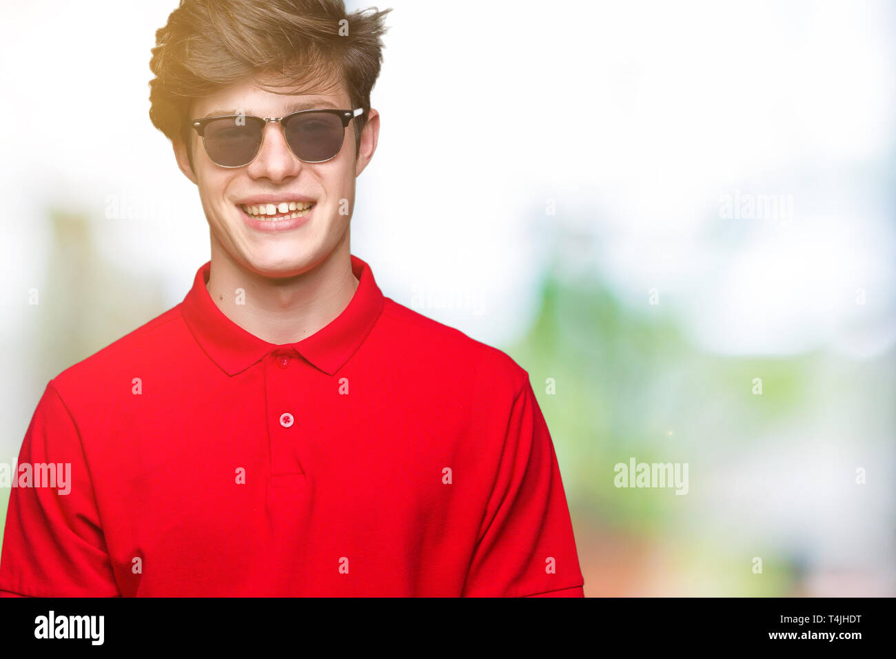Young handsome man wearing sunglasses over isolated background with a ...