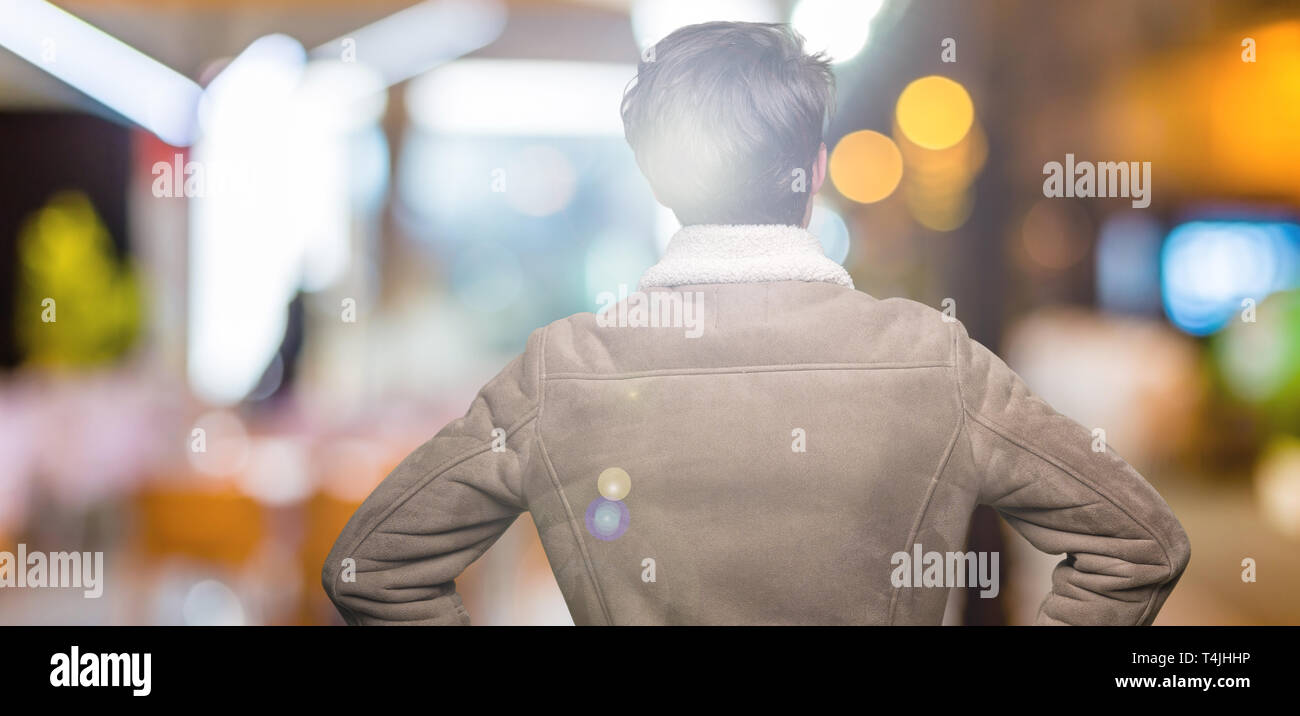 Young handsome man wearing winter coat over isolated background ...