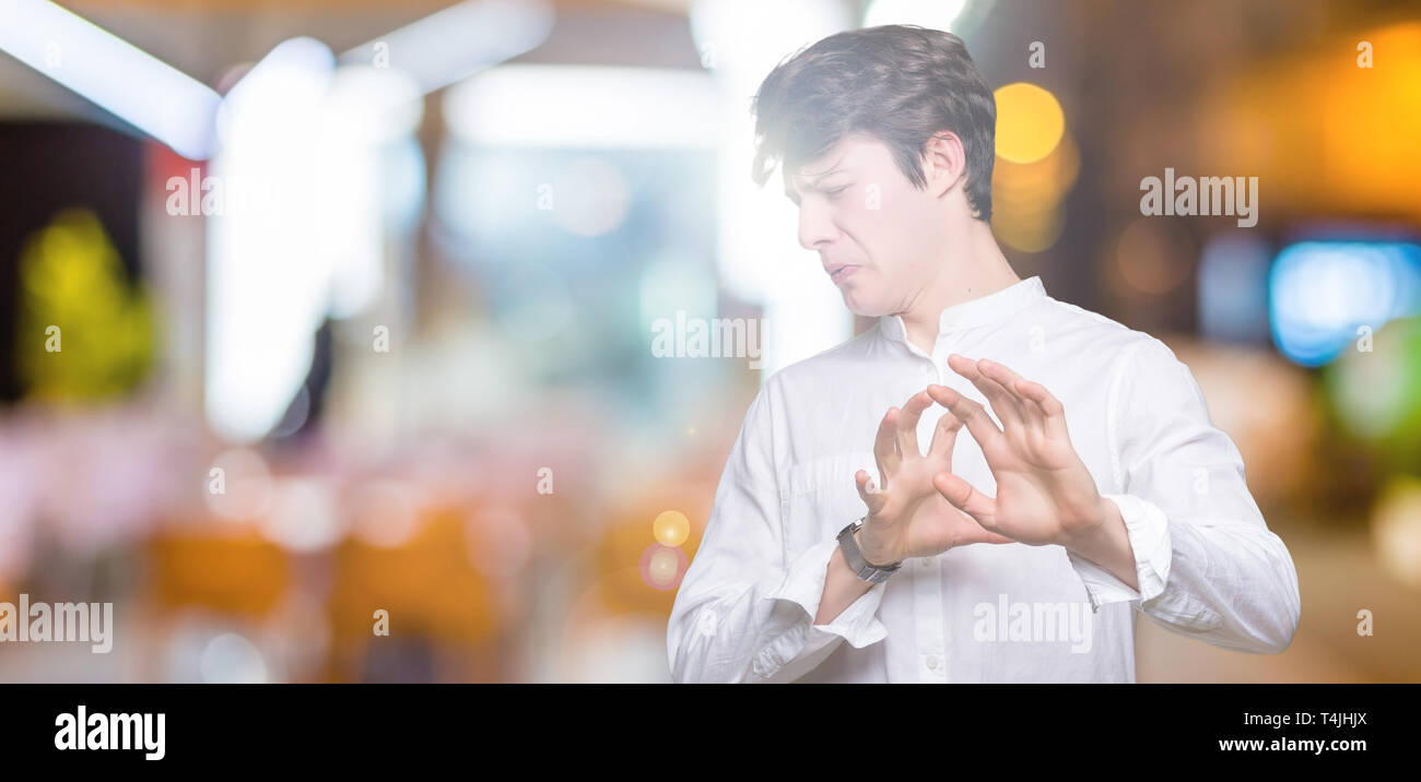 Young handsome business man over isolated background disgusted ...