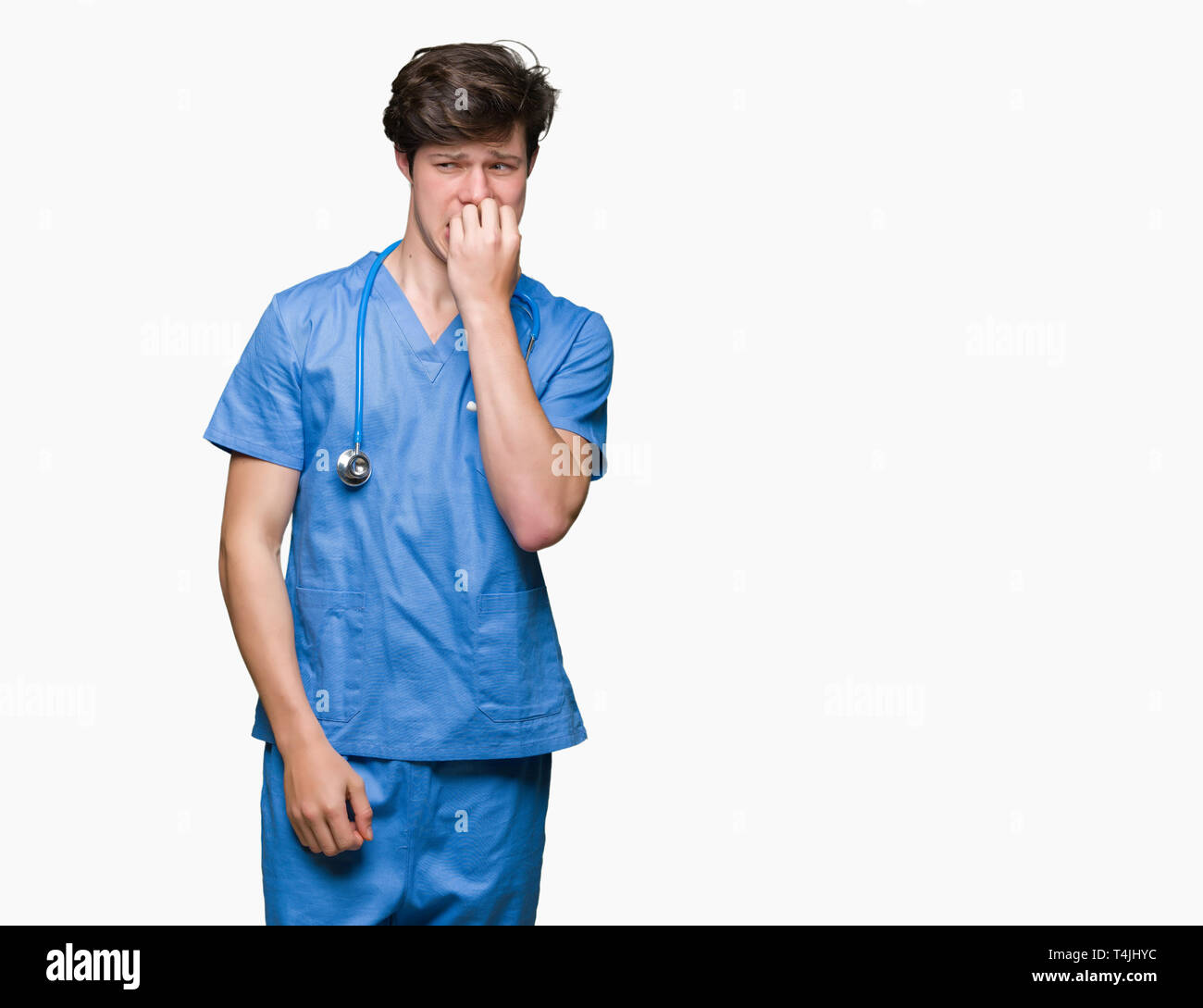 Young doctor wearing medical uniform over isolated background looking ...