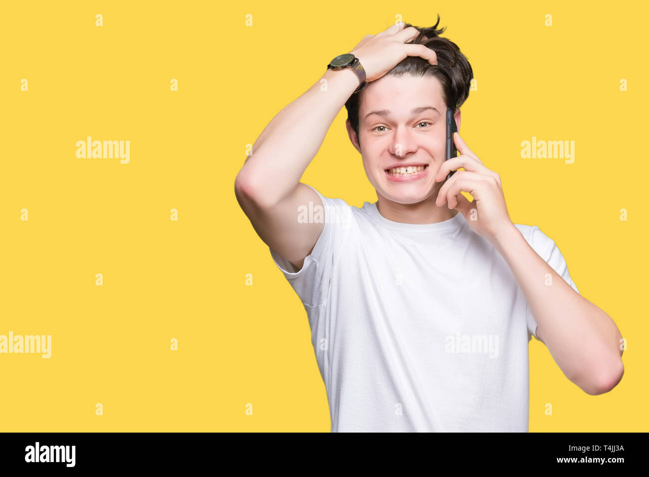 Young man talking on smartphone over isolated background stressed with ...