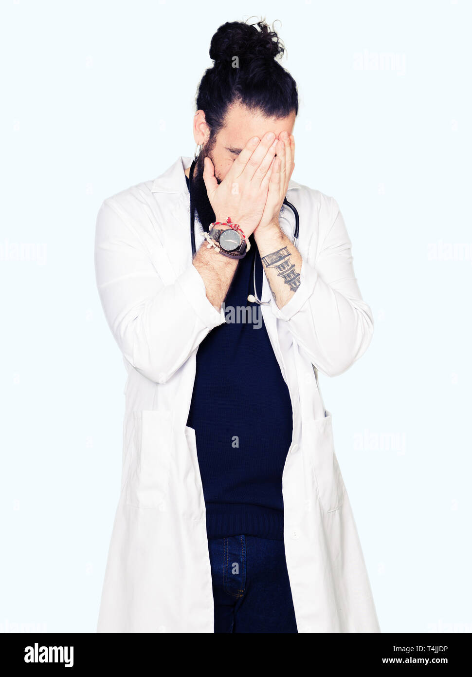 Doctor with long hair wearing medical coat and stethoscope with sad ...