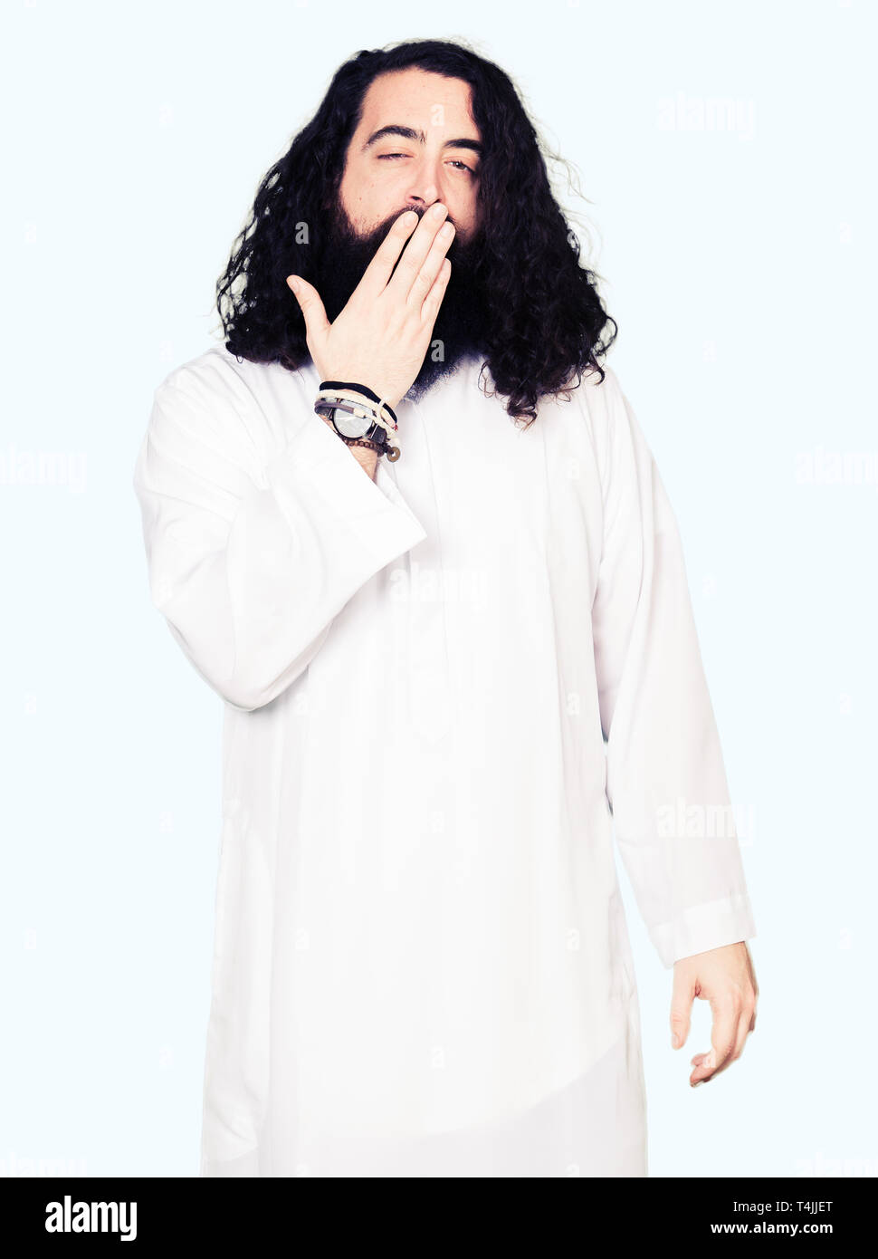 Man wearing Jesus Christ costume bored yawning tired covering mouth ...