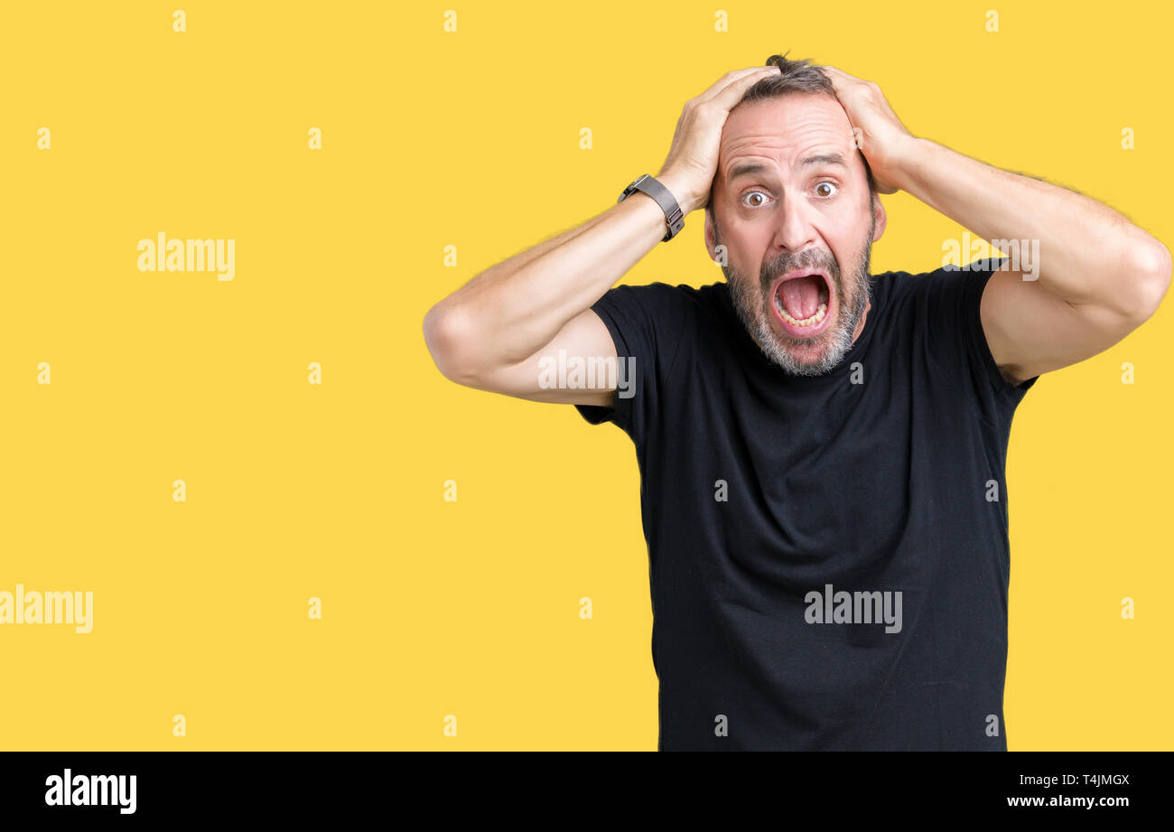 Handsome middle age hoary senior man over isolated background Crazy and ...