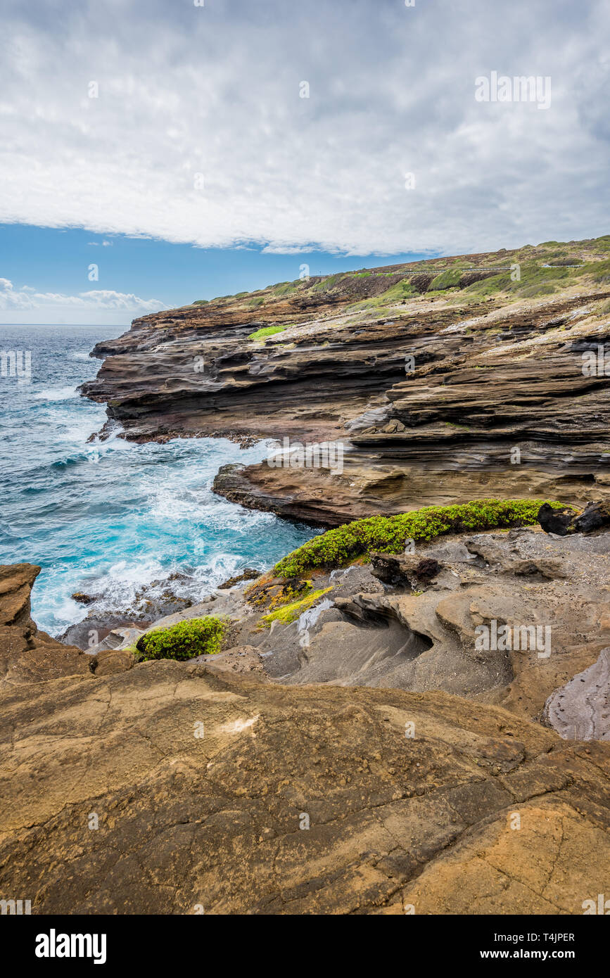 Ocean waves swirling around the unique lava rock formations of the ...