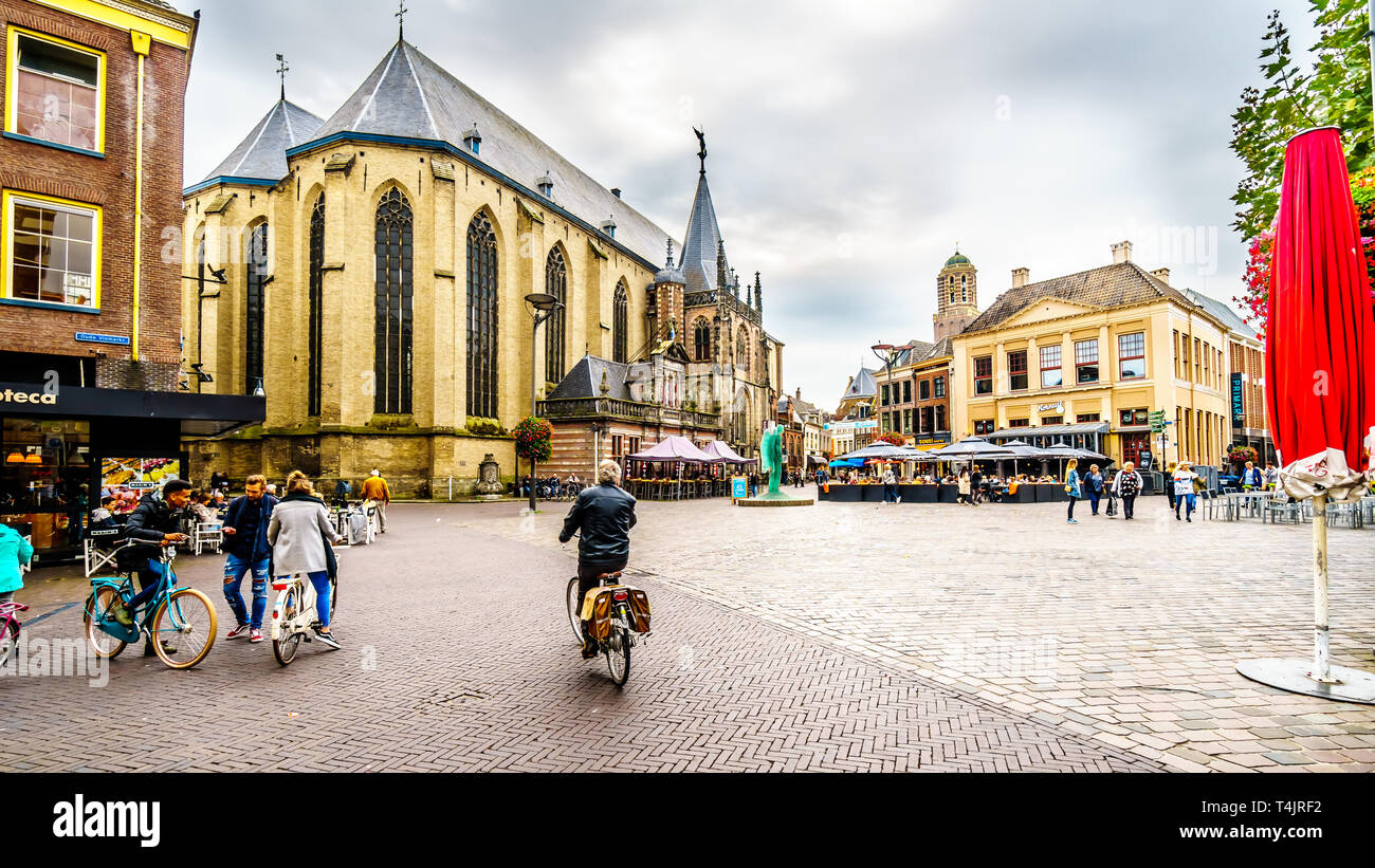 People walking, biking and hanging out at the center square, named ...