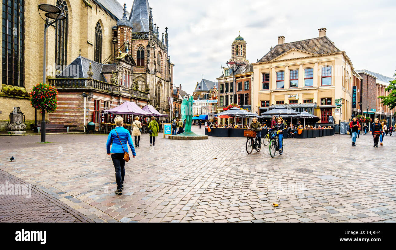 People walking, biking and hanging out at the center square, named ...