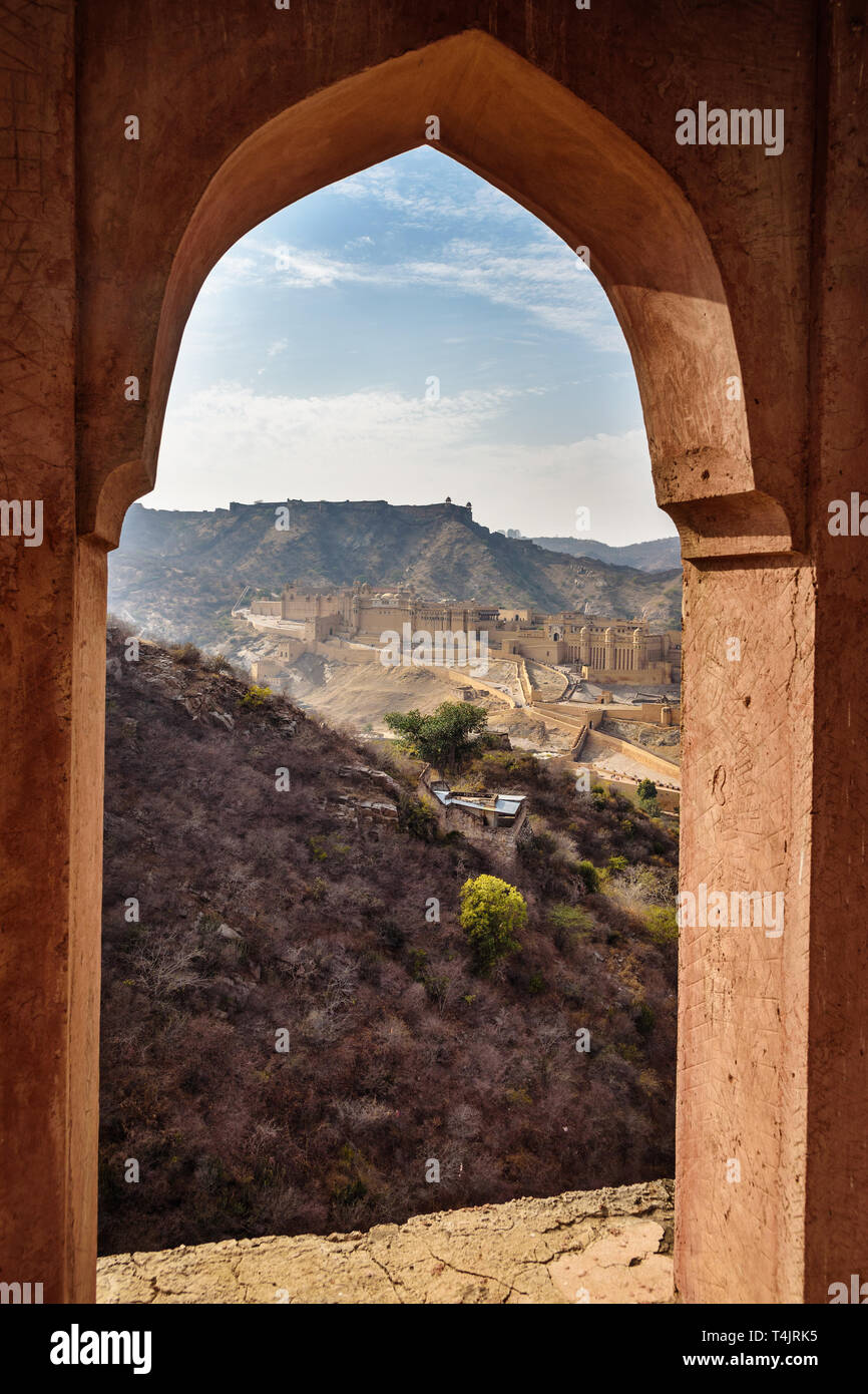 View of Amber fort and palace through the arch of tower walls. Jaipur ...
