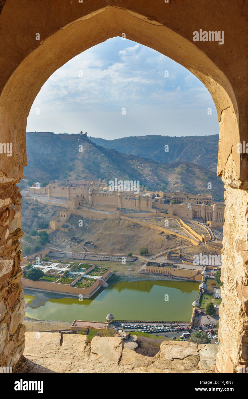 View of Amber fort and palace through the arch of tower walls. Jaipur ...