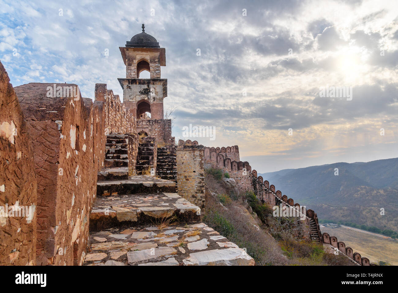 Ancient long wall with towers around Amber Fort at sunset. Jaipur ...