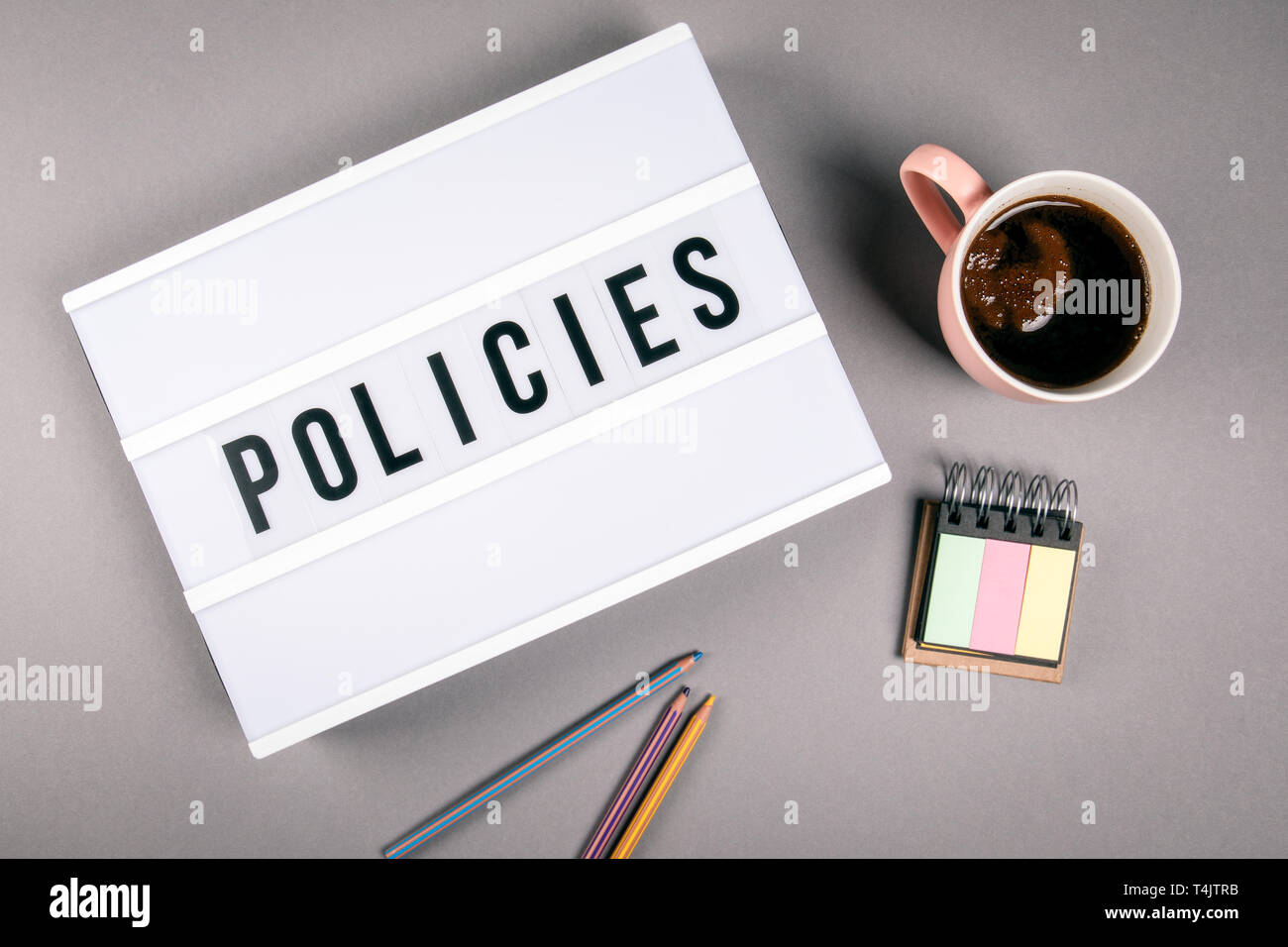 Policies. Text in light box. Pink coffee mug on gray background Stock ...