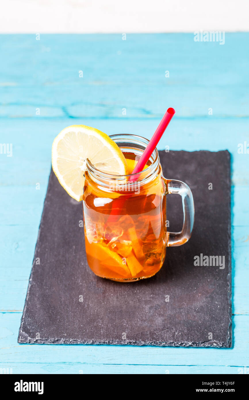 Iced tea in a glass jar with lemon Stock Photo - Alamy
