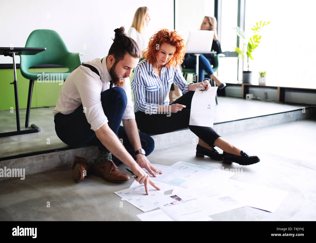 Two colleagues looking at paper hi-res stock photography and images - Alamy