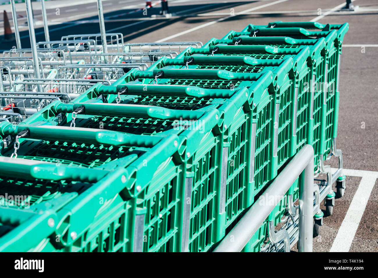 Line of green shopping carts in a supermarket. Outdoor shot Stock Photo ...