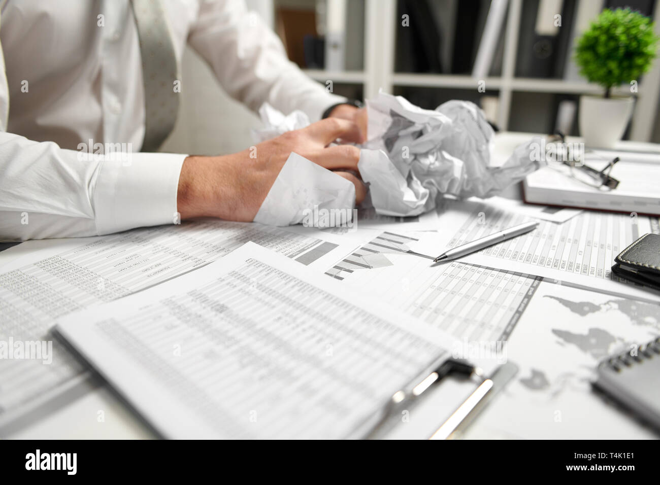 Angry businessman has stress and troubles with bad reports, he breaks ...