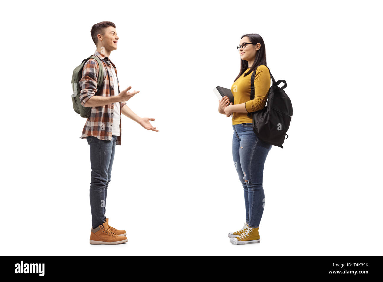 Full length profile shot of male and female students talking isolated ...