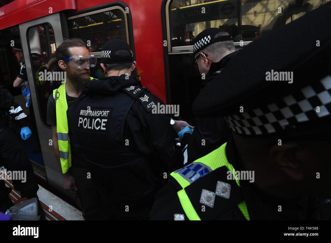 British Transport Police Officers try to remove a climate activist ...