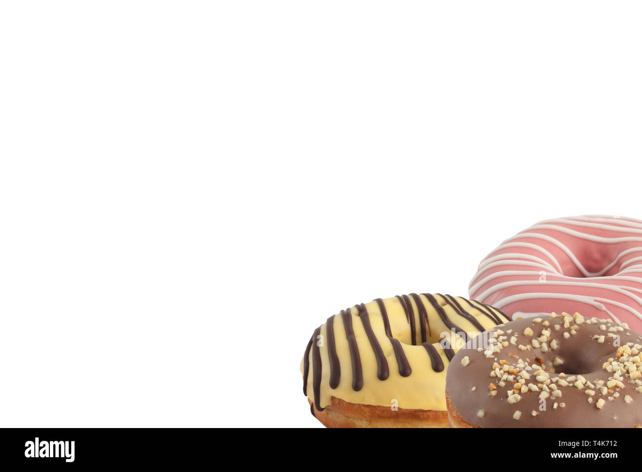 Different bright tasty donuts on a white background. Place under the ...