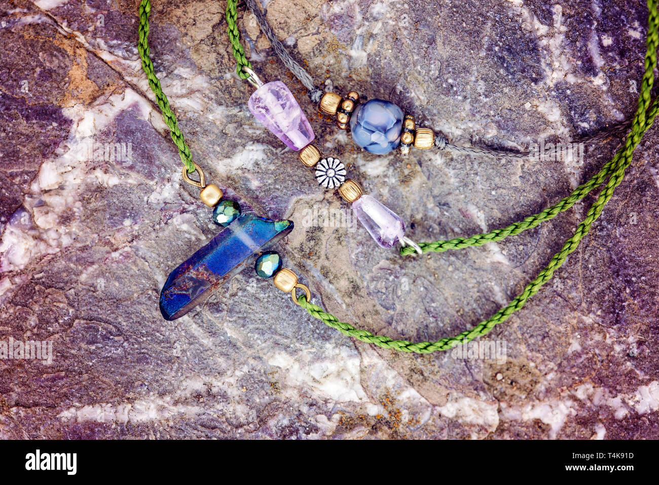 Natural stone bead tiny three bracelets on rocky background Stock Photo ...