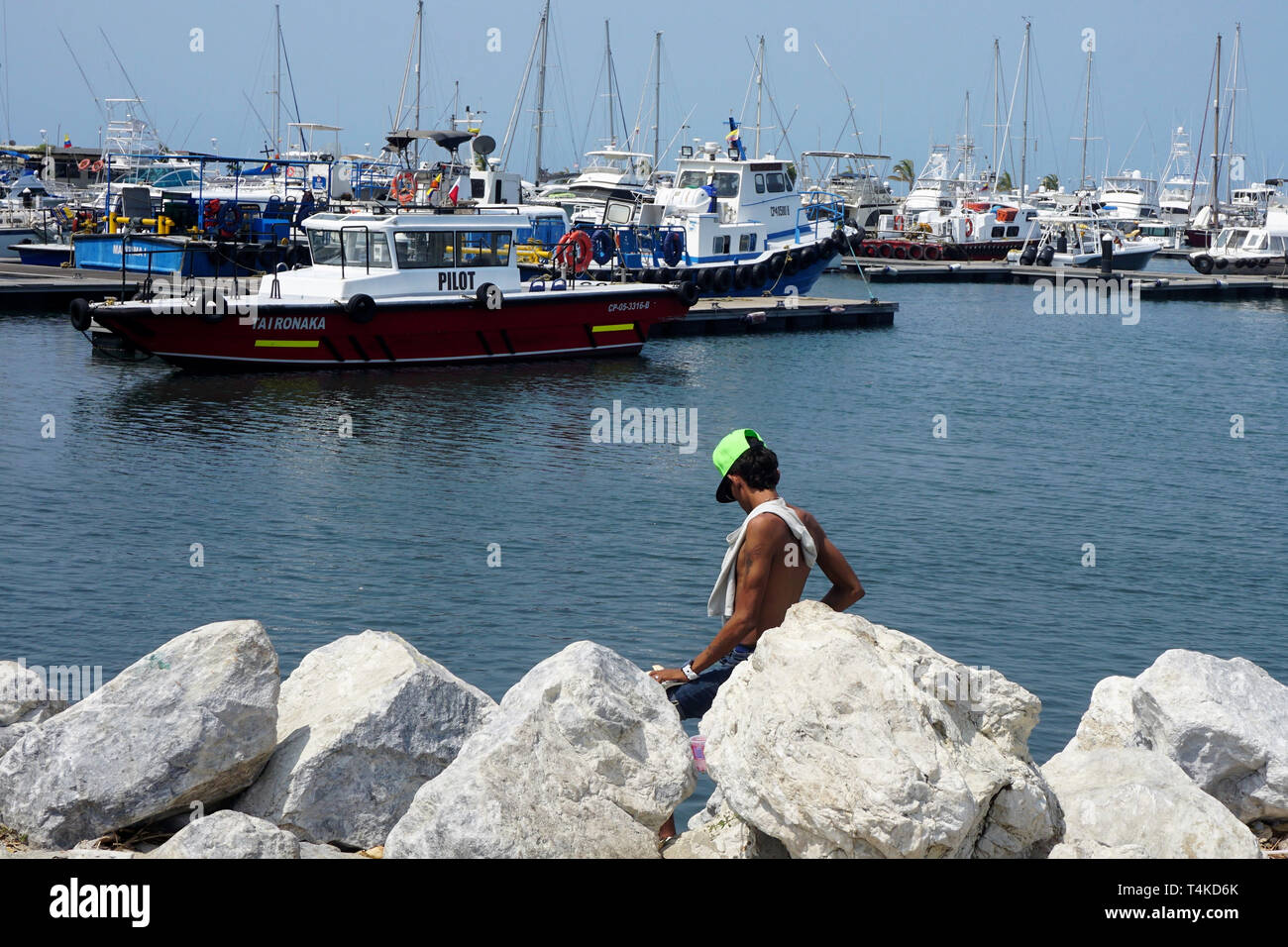 Young man behind rock hi-res stock photography and images - Alamy