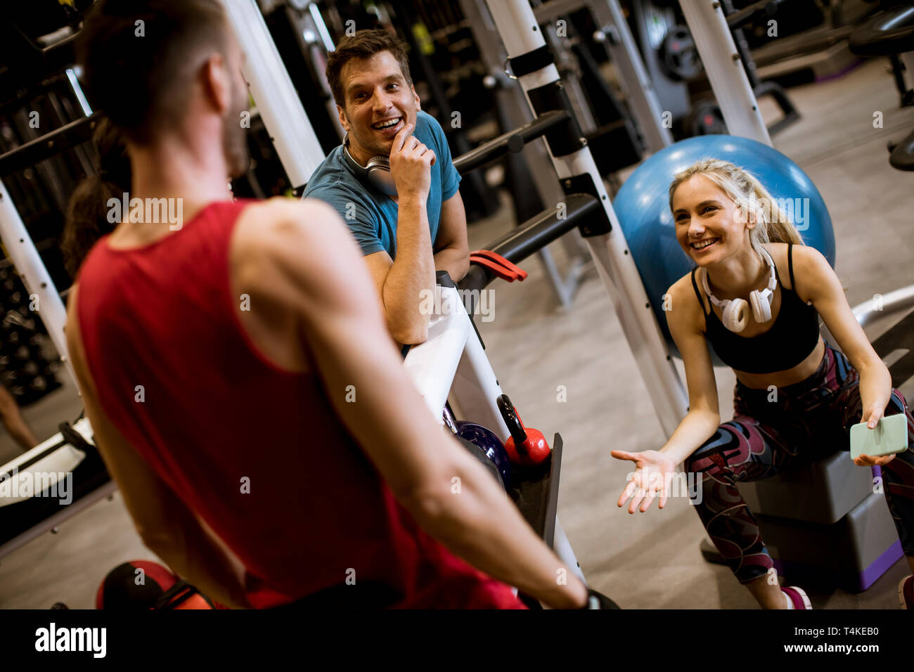 Group of young people in sportswear talking in a gym after a workout ...