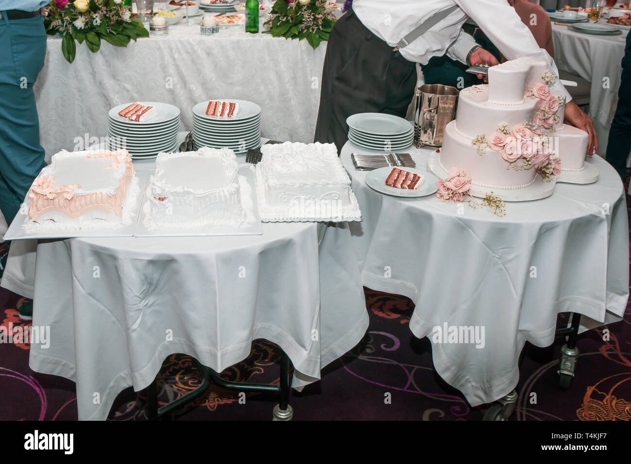 Restaurant waiter serving dessert table with wedding cakes Stock Photo ...