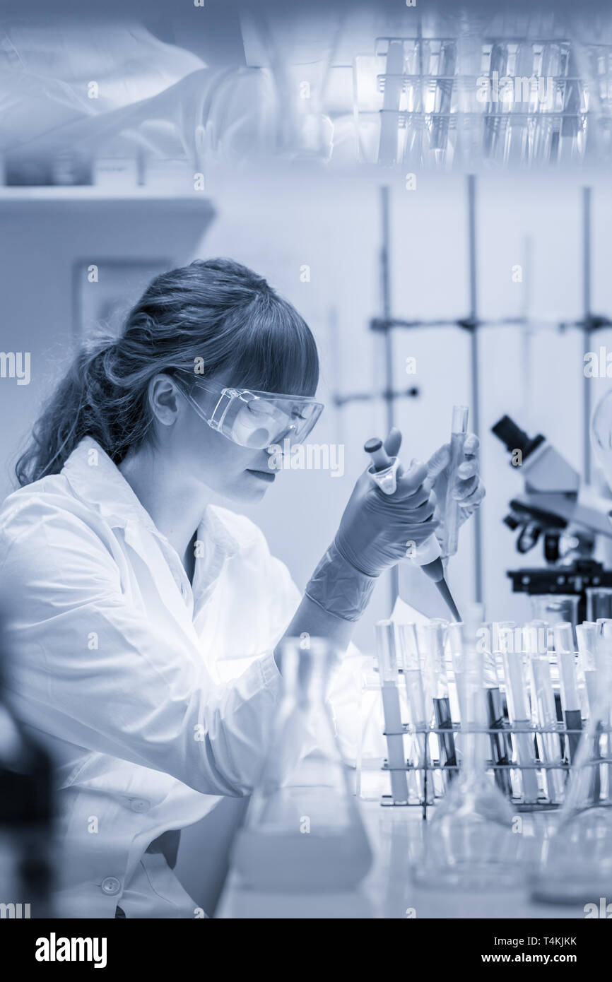 Young scientist pipetting in life science laboratory Stock Photo - Alamy