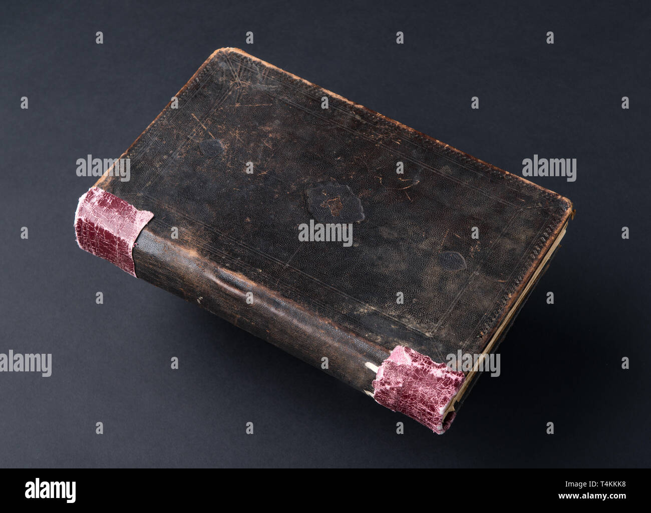 old shabby book on a black background. ancient handwritten book Stock ...