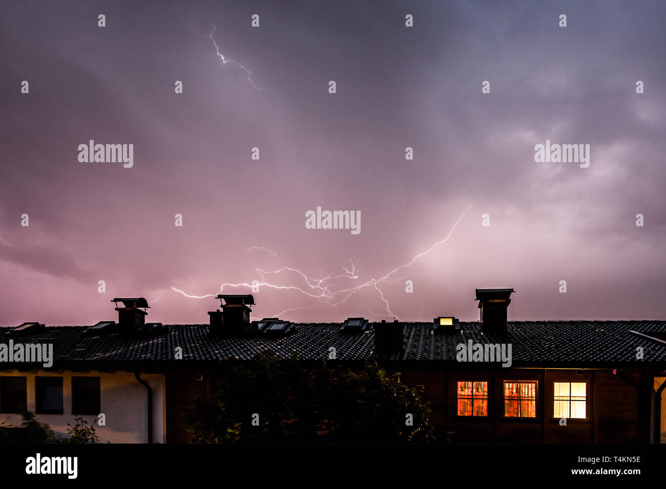 Lightning on the colored sky, roof of a building Stock Photo - Alamy