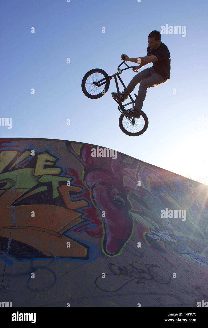 bmx biker jump at skate park in silhouette profile Stock Photo - Alamy