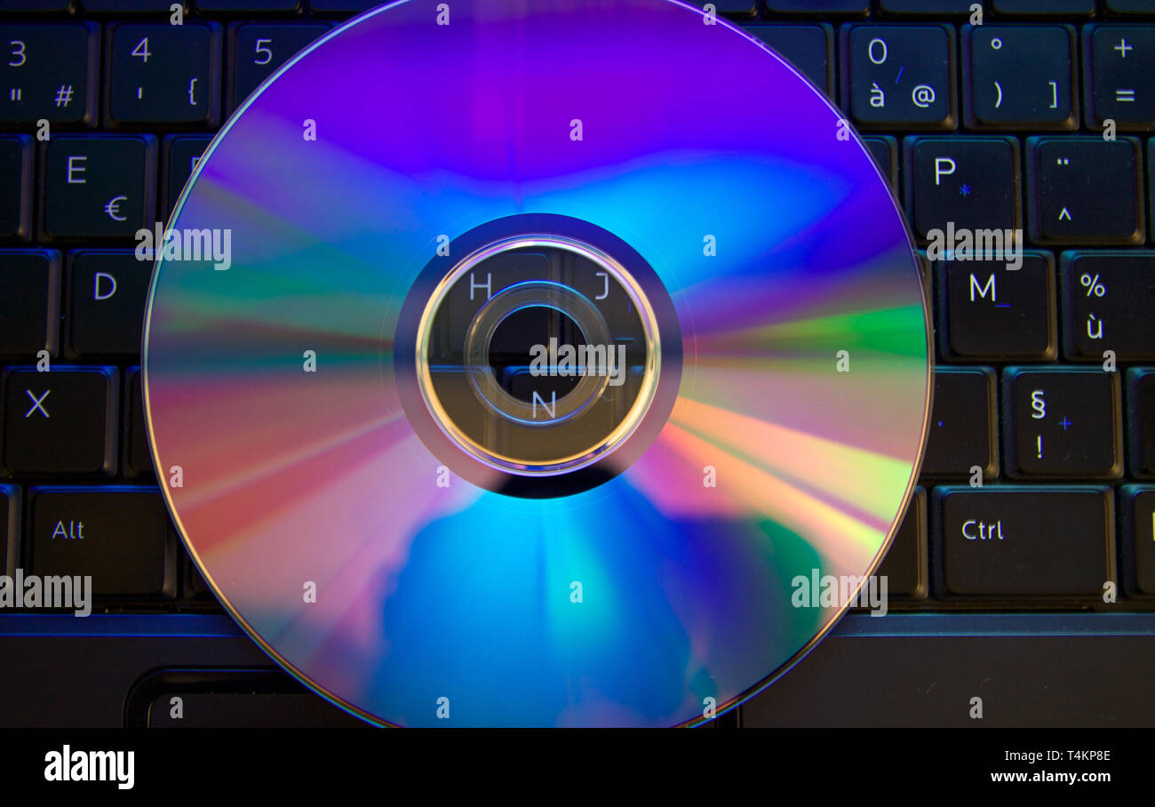 rainbow from compact disk sitting on top of an illuminated computer ...