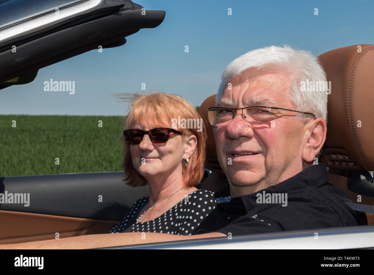 Senior couple in sports car Stock Photo - Alamy