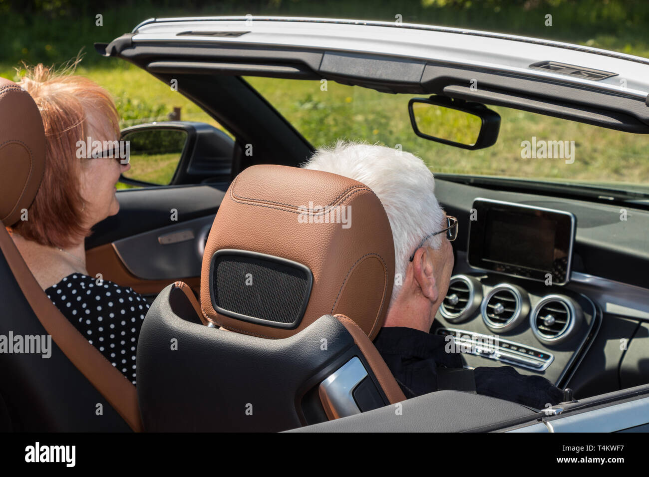 Senior couple in sports car Stock Photo - Alamy