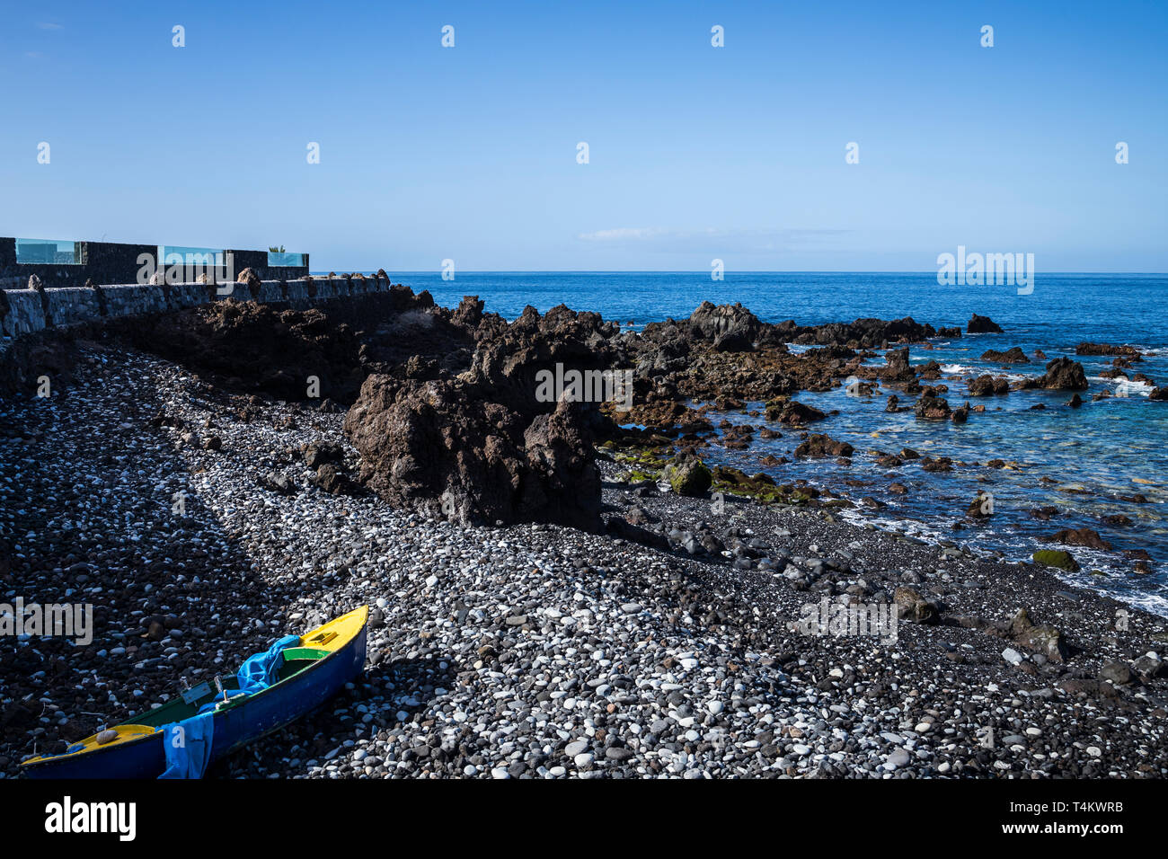 Old wooden rowing boat on a stony rocky beach in a cove at Fonsalia ...