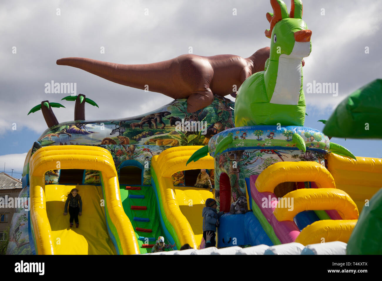 happy excited girl having fun on inflatable attraction playground ...