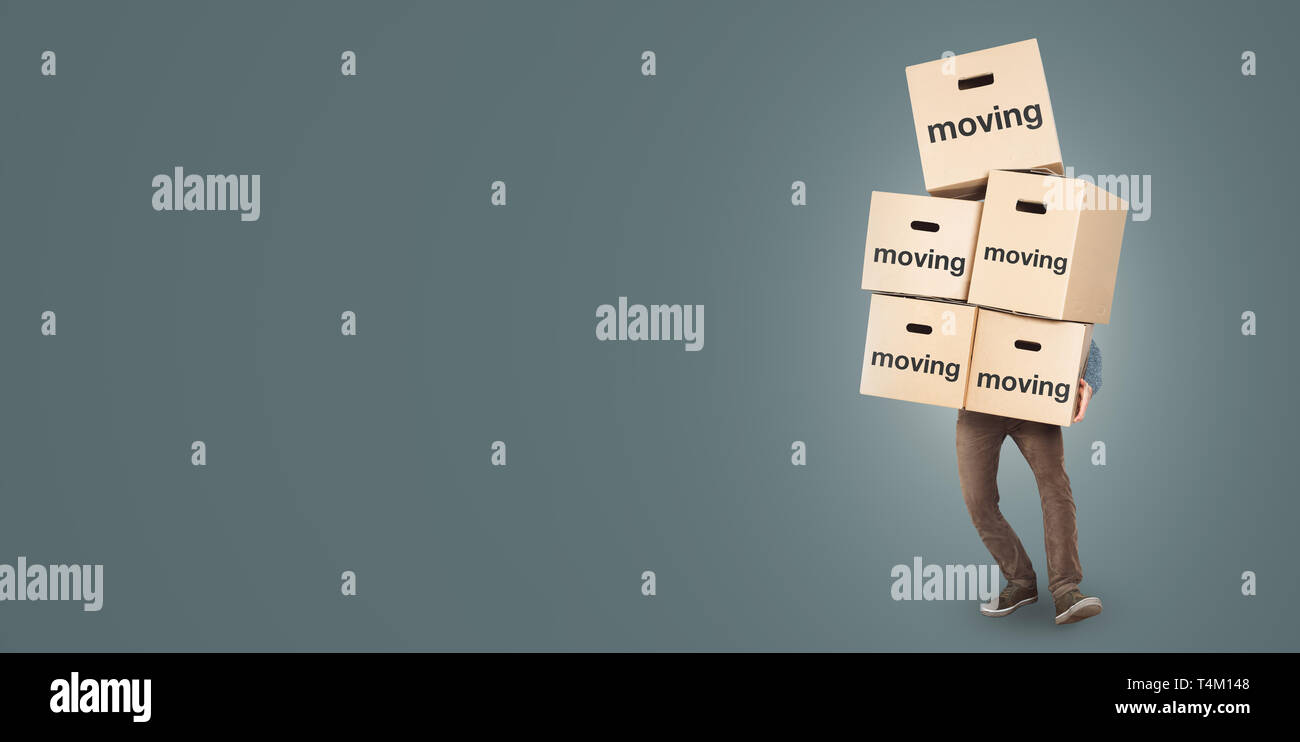 A man is carrying many moving boxes - isolated on a neutral background ...